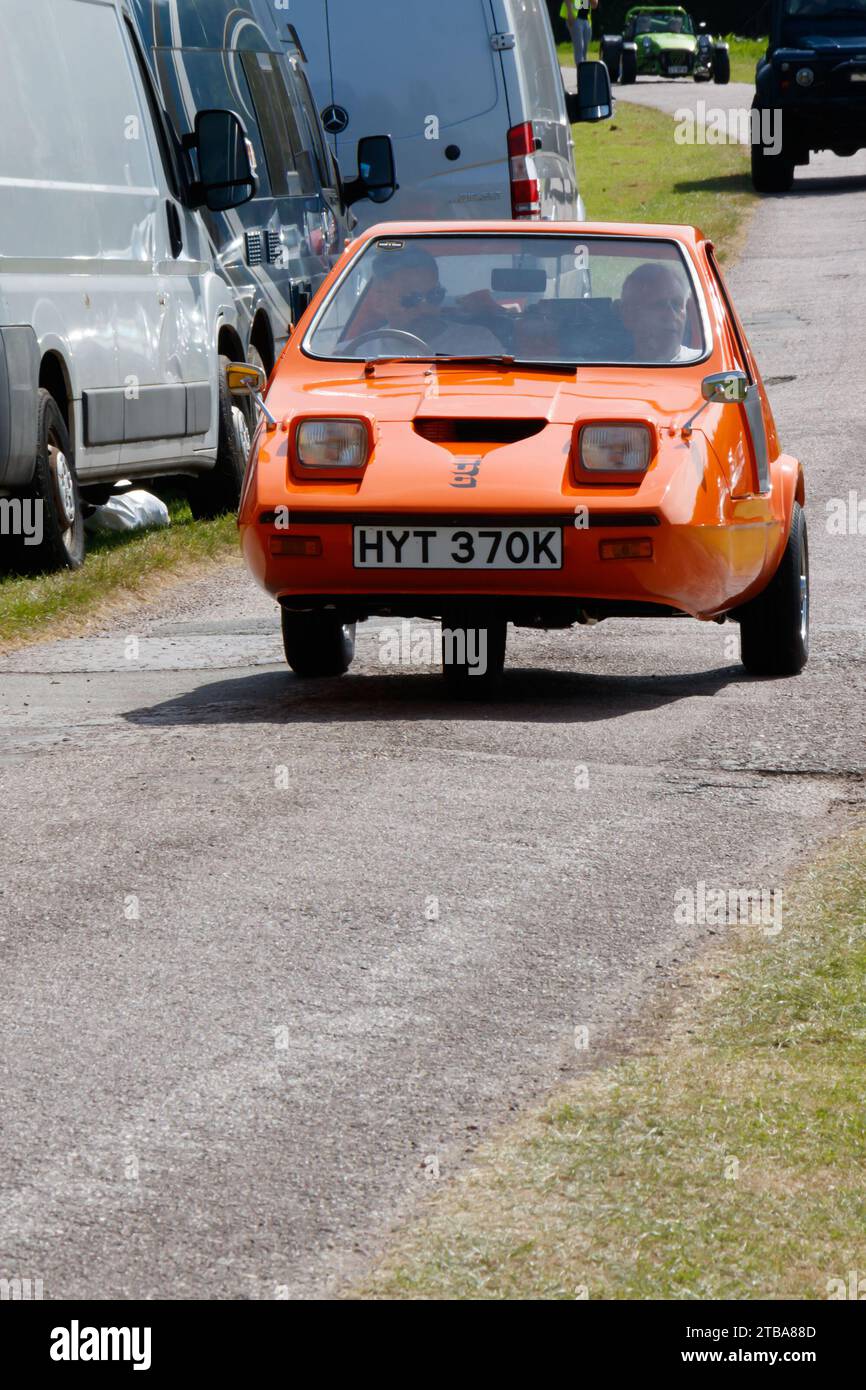 orange classic reliant robin three wheeler driving on road Stock Photo ...