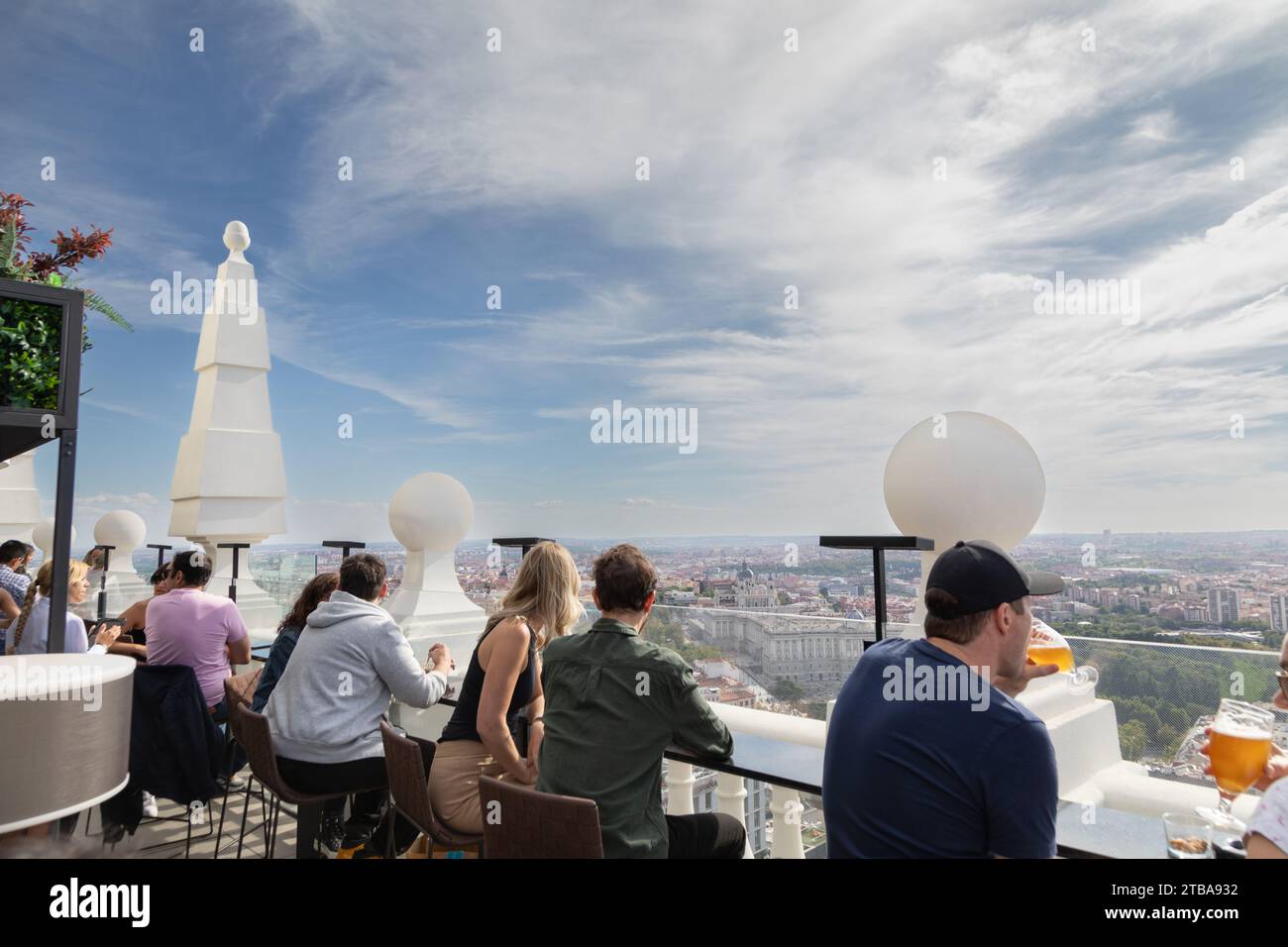 People drinking and enjoying the view of Madrid from the rooftop bar ...