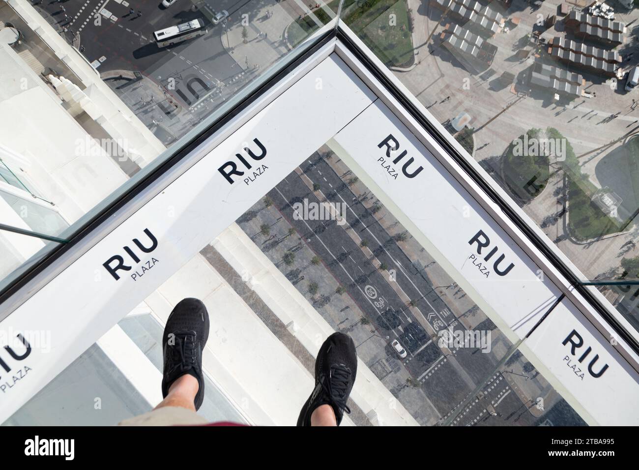 Person looking down tall and small hi-res stock photography and images ...