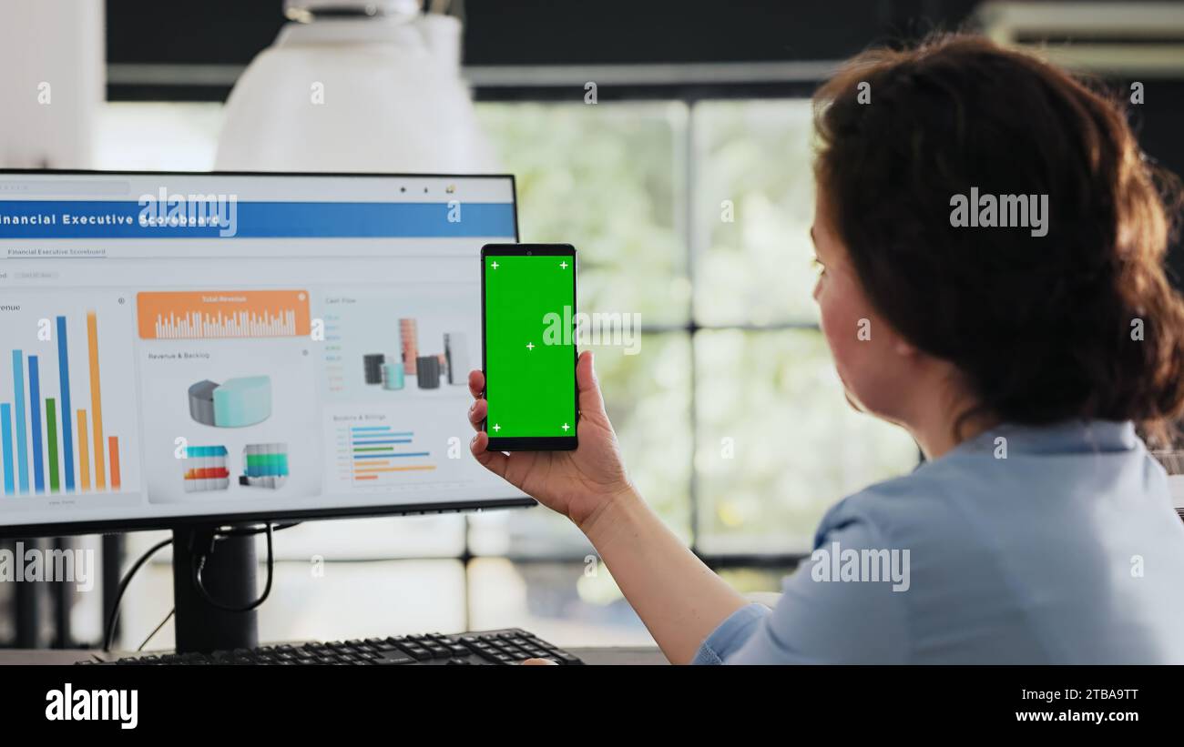 Manager holding phone with greenscreen in coworking space business ...