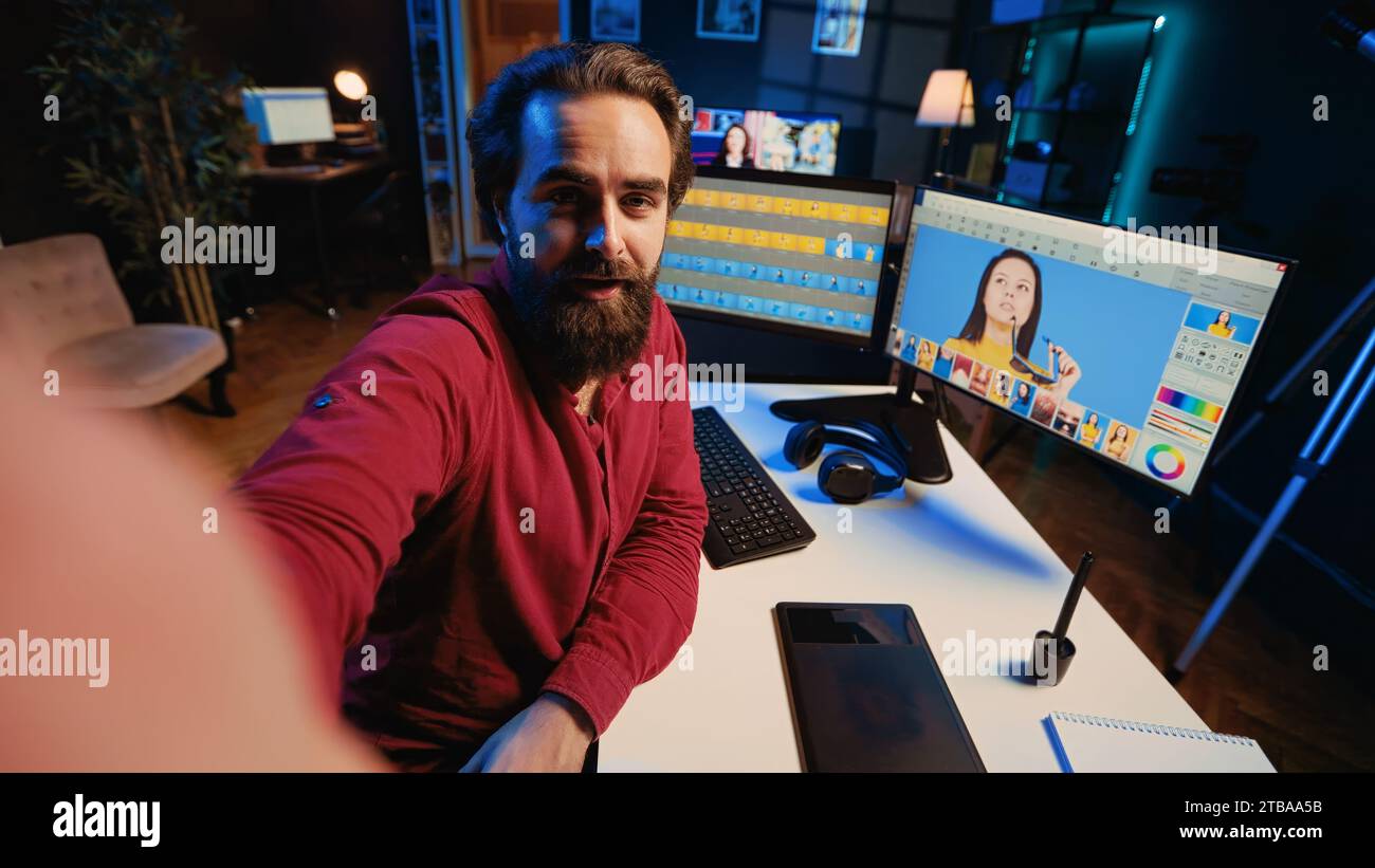 Videographer recording tutorial using smartphone selfie camera, talking ...