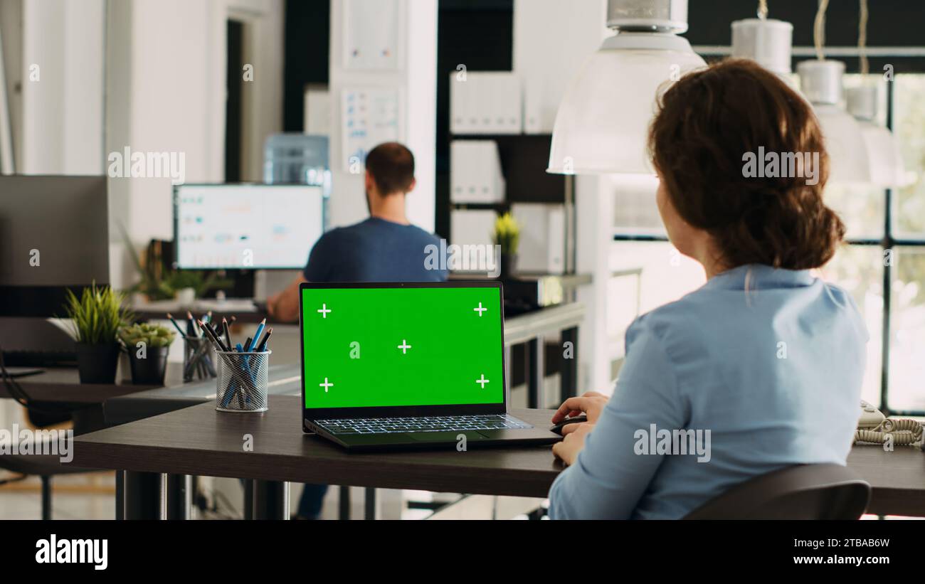 Startup worker checks greenscreen on pc working in creative agency open ...