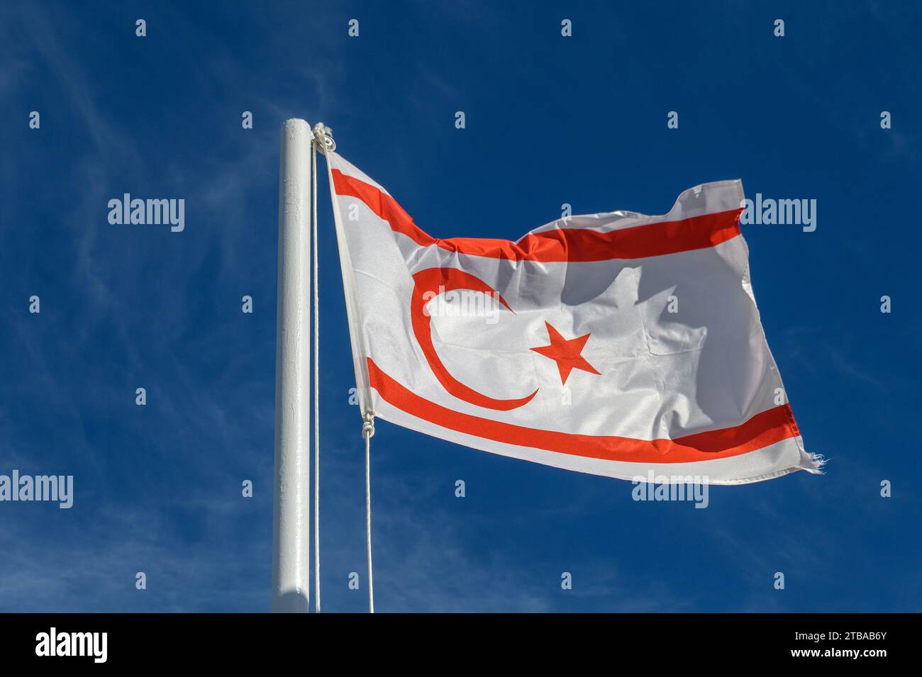 flag of the Turkish Republic of Northern Cyprus against a blue sky ...