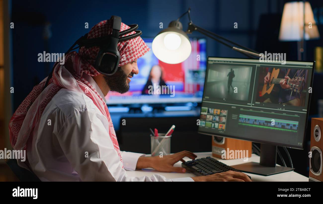 Muslim cinematographer wearing headphones while editing project ...