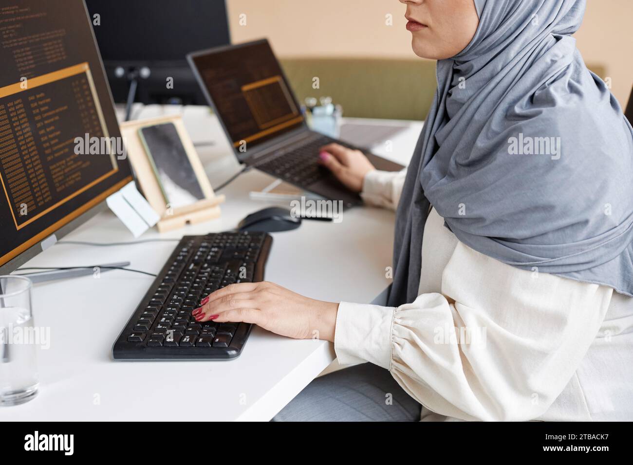Closeup of Muslim young woman working as female software developer and ...