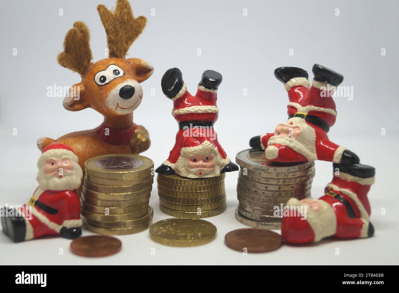 Santa Clauses, elk, and Euro coins, symbol picture for end-of-year ...