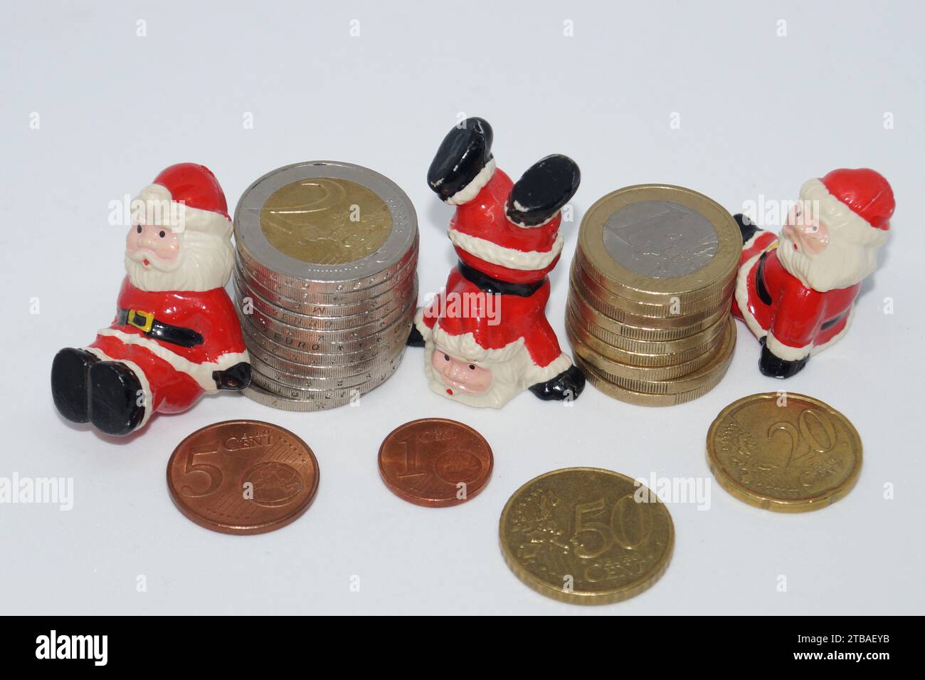 Santa Clauses and coin piles, symbol picture for end-of-year bonus ...