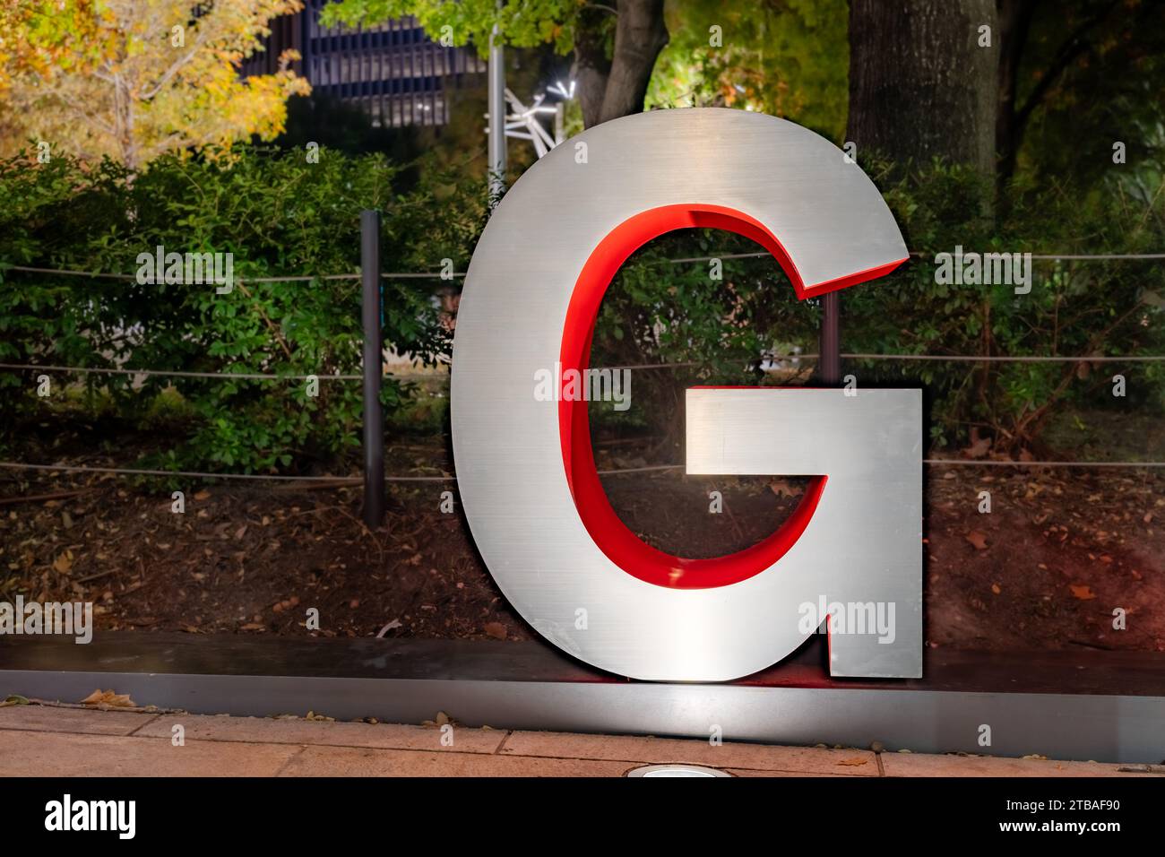 Red and gray three-dimensional 3d letter G with an evening outdoor ...