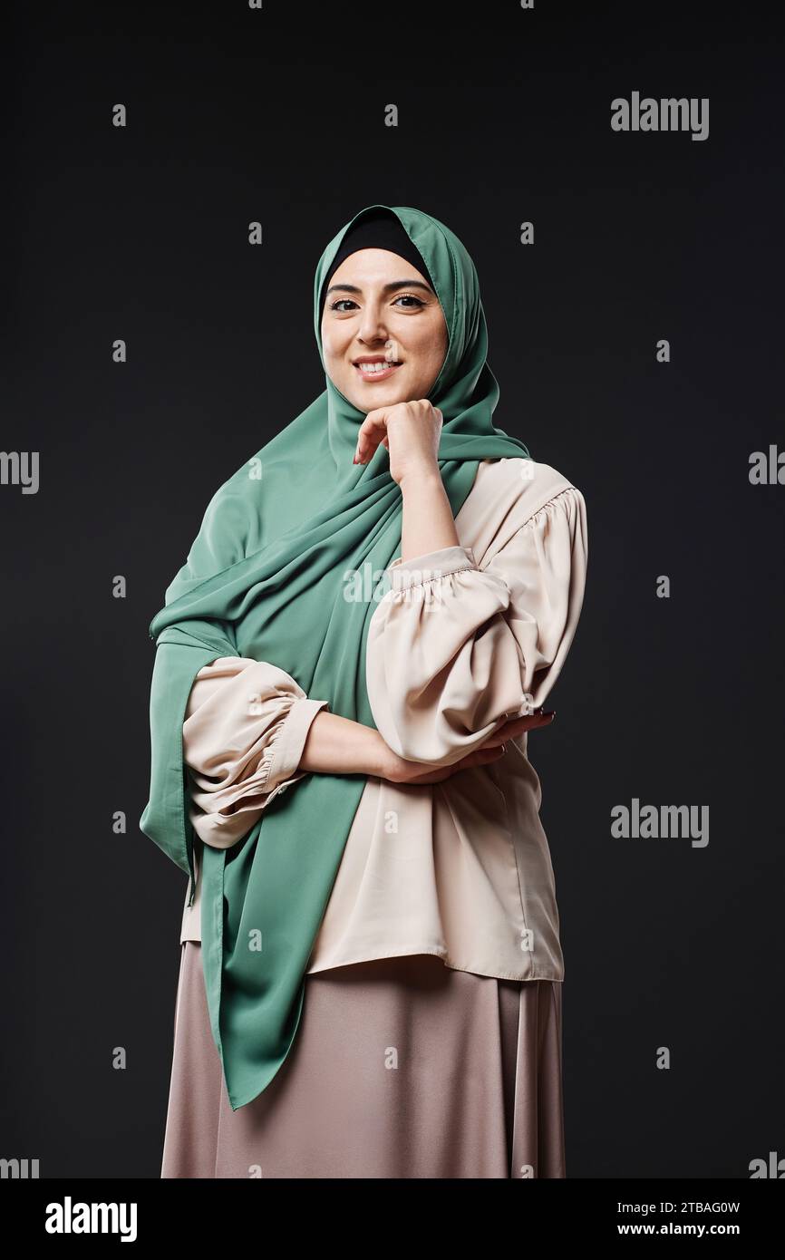 Vertical portrait of young Muslim woman wearing modest clothing and ...