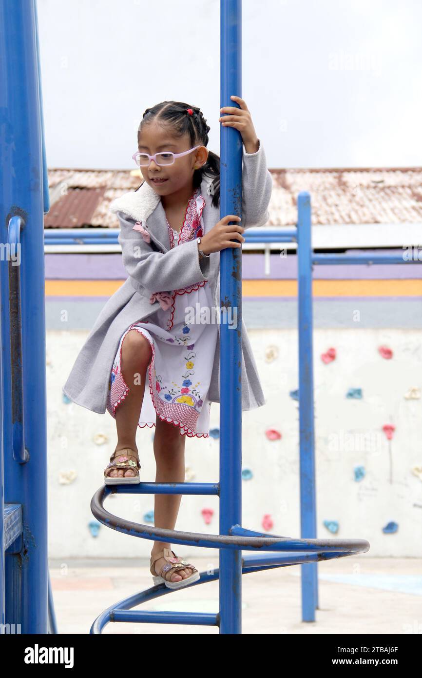 Indigenous 4 year old girl with traditional dress and huaraches plays ...
