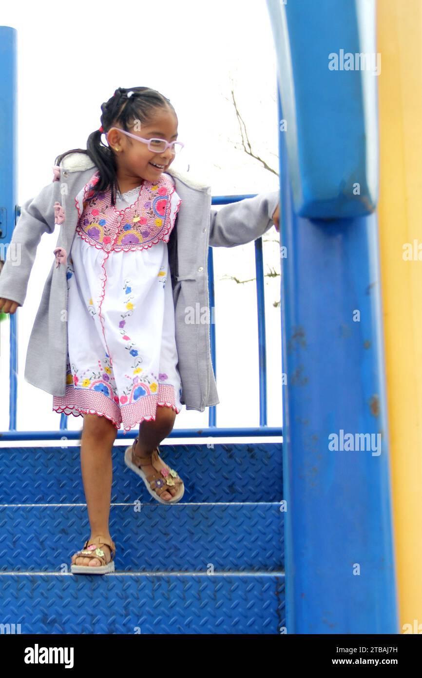 Indigenous 4 year old girl with traditional dress and huaraches plays ...