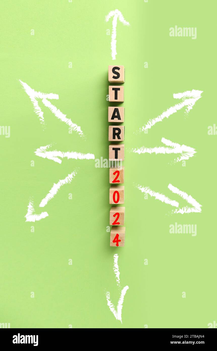 Banner with wooden cubes, text START 2024 and drawn arrows on green ...
