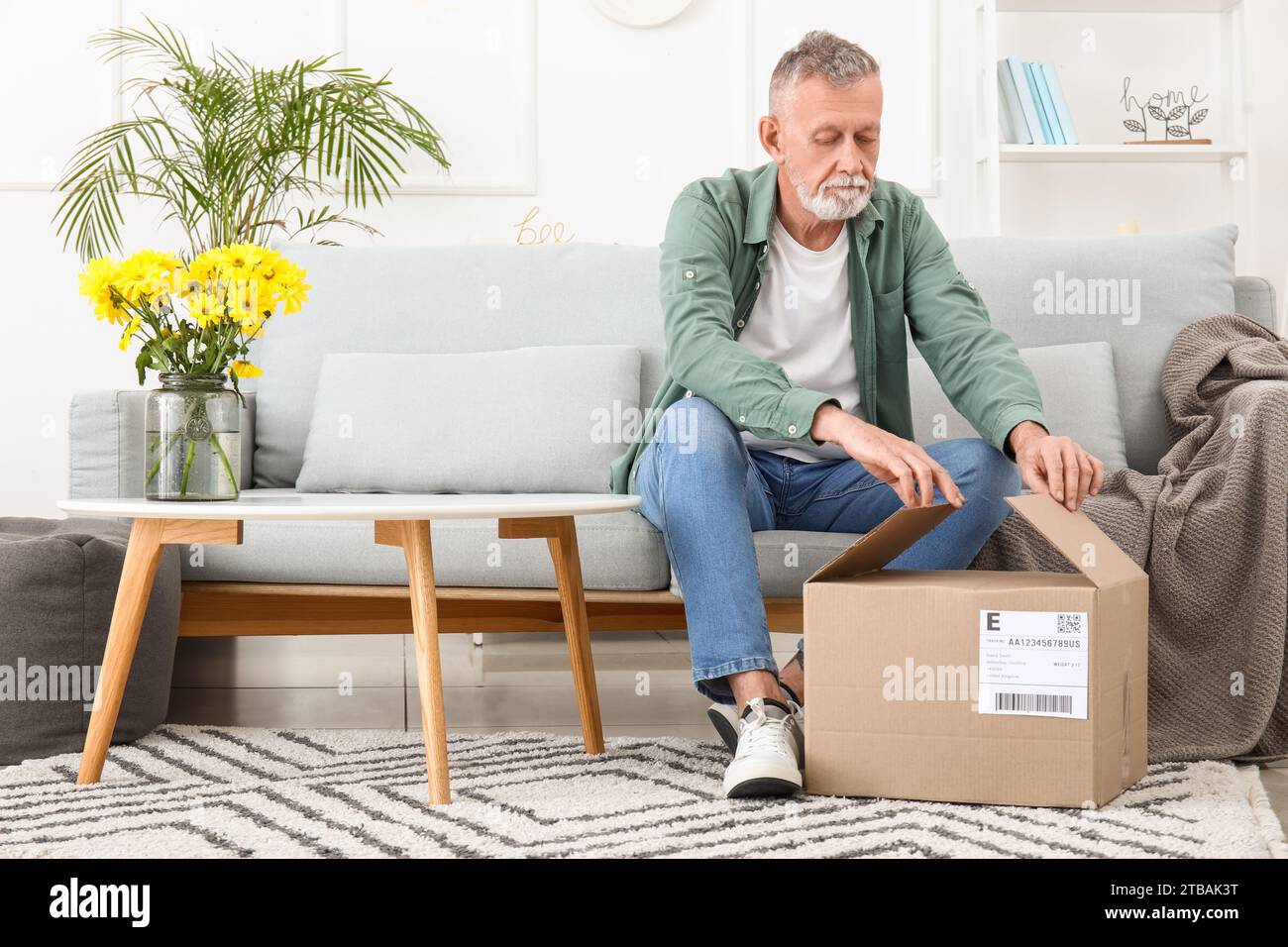Old man opening cardboard box hi-res stock photography and images - Alamy
