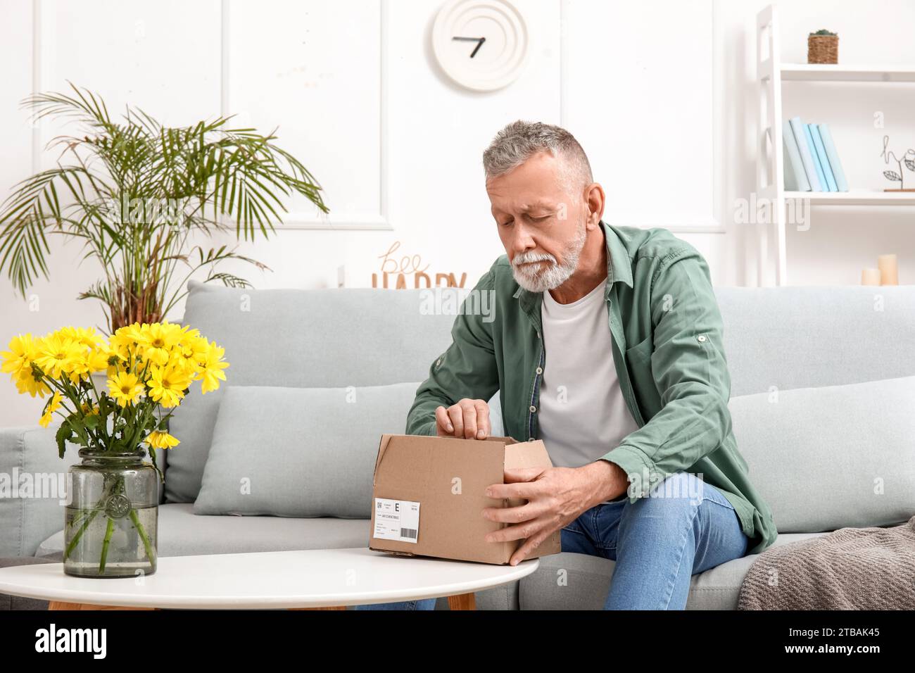 Old man opening cardboard box hi-res stock photography and images - Alamy