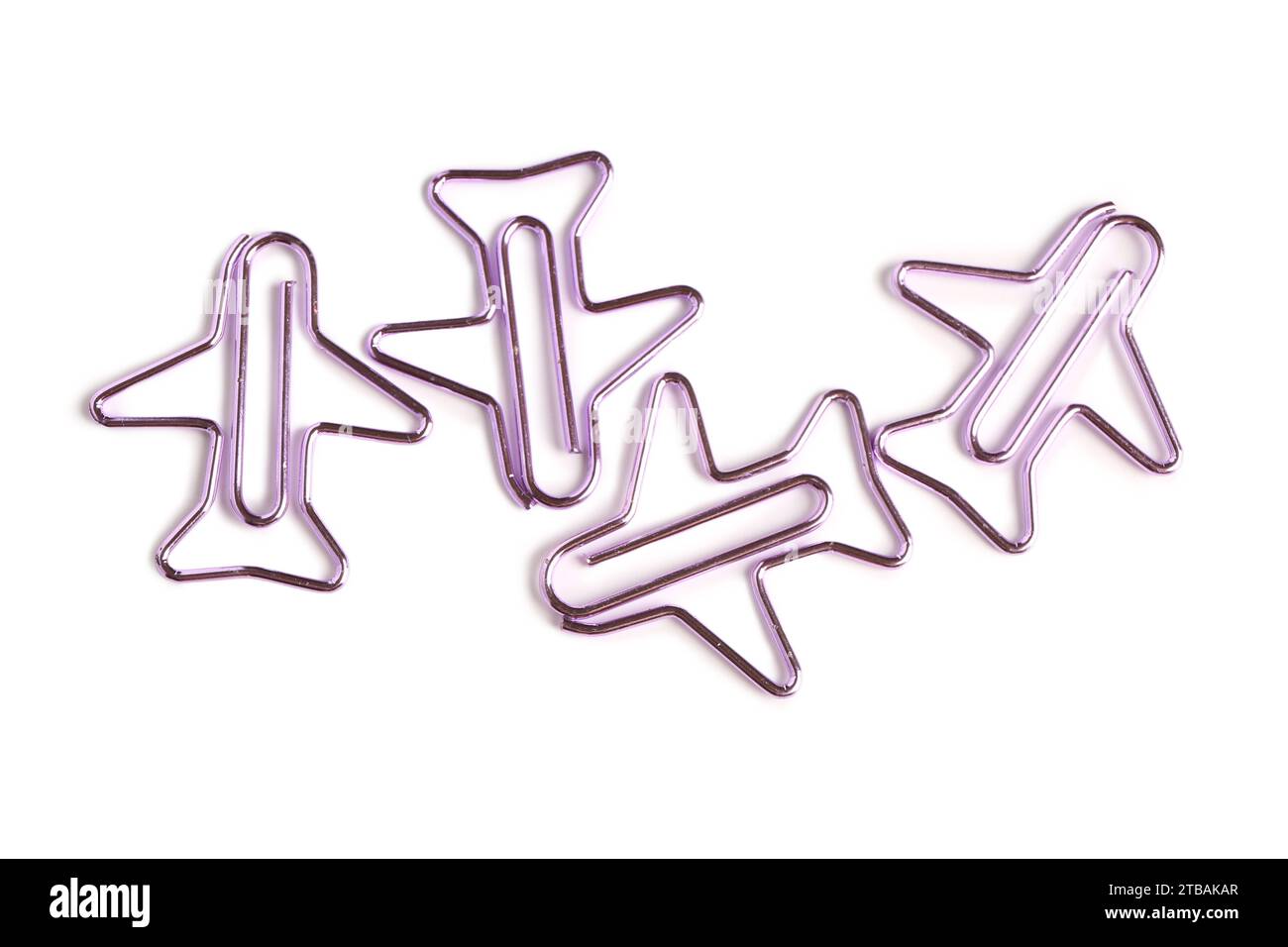 Purple paper clips in shape of airplanes on white background Stock ...