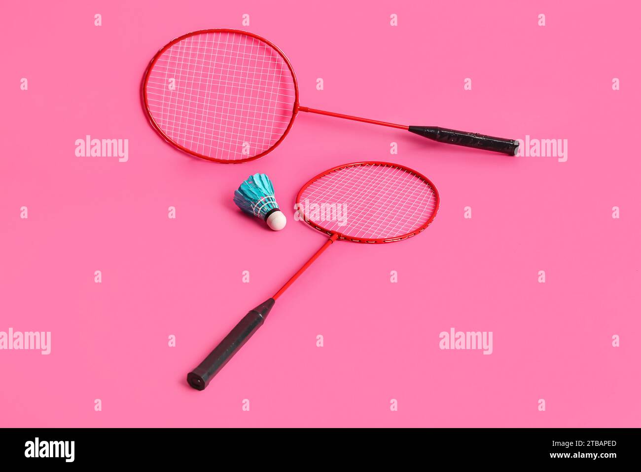 Badminton rackets and shuttlecock on pink background Stock Photo - Alamy