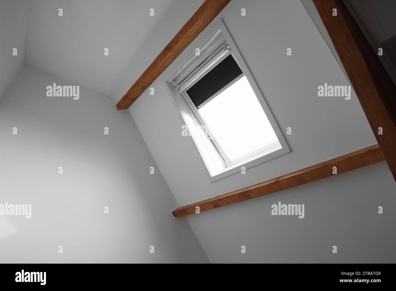 Roof window on slanted ceiling indoors, low angle view Stock Photo - Alamy