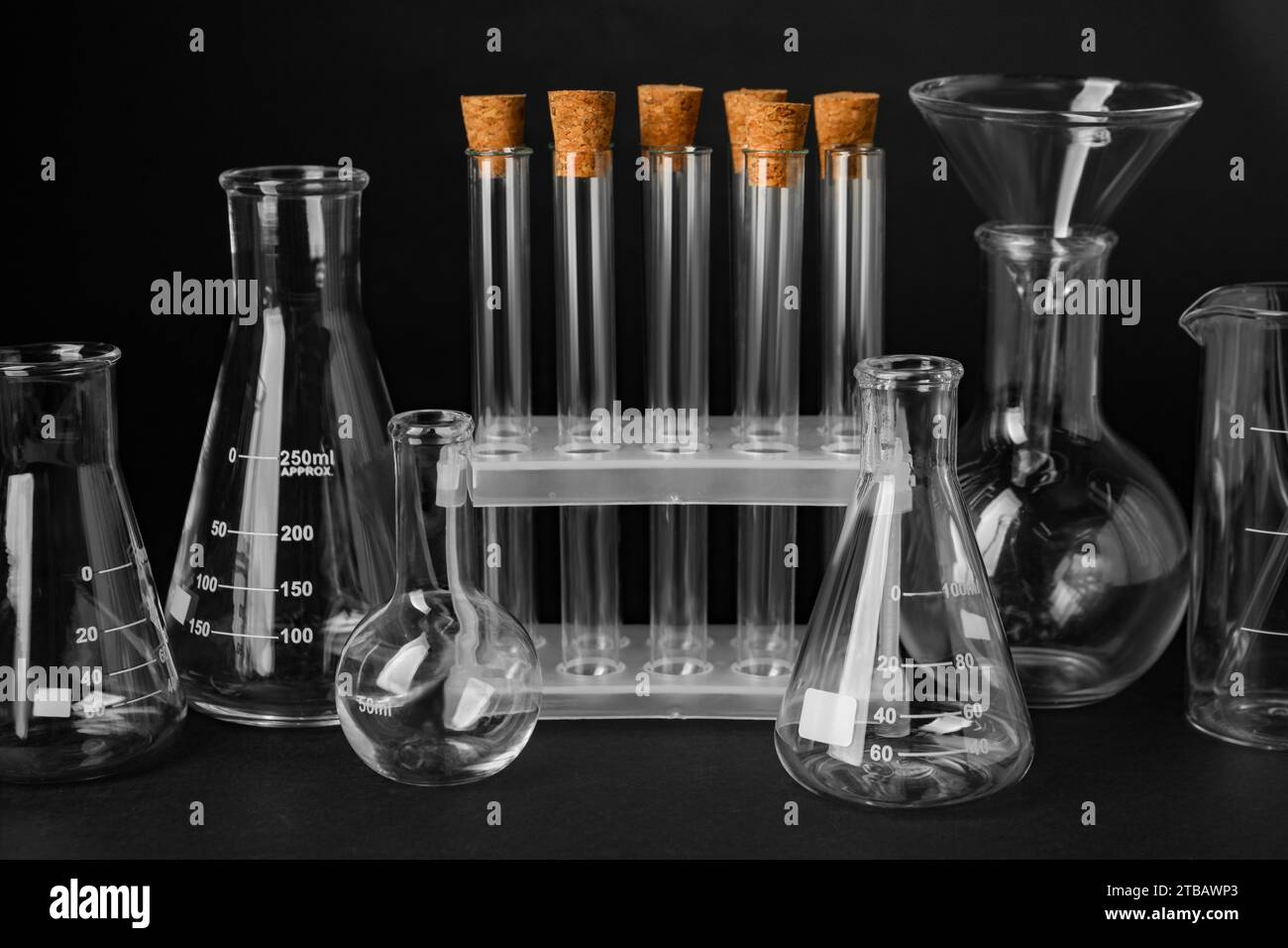 Different laboratory flasks and test tubes on black background Stock ...
