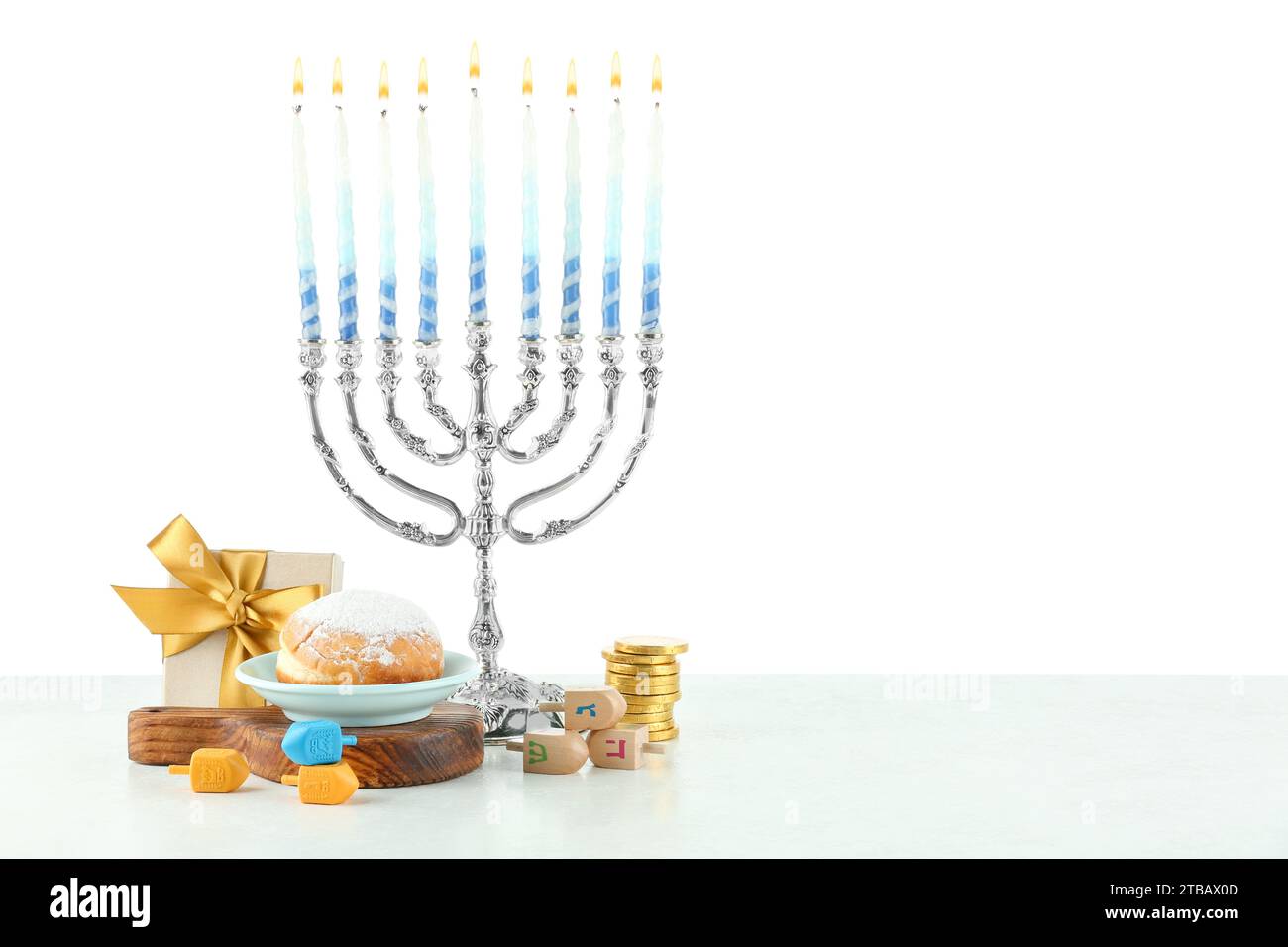 Hanukkah celebration. Menorah with colorful candles, dreidels, donuts ...