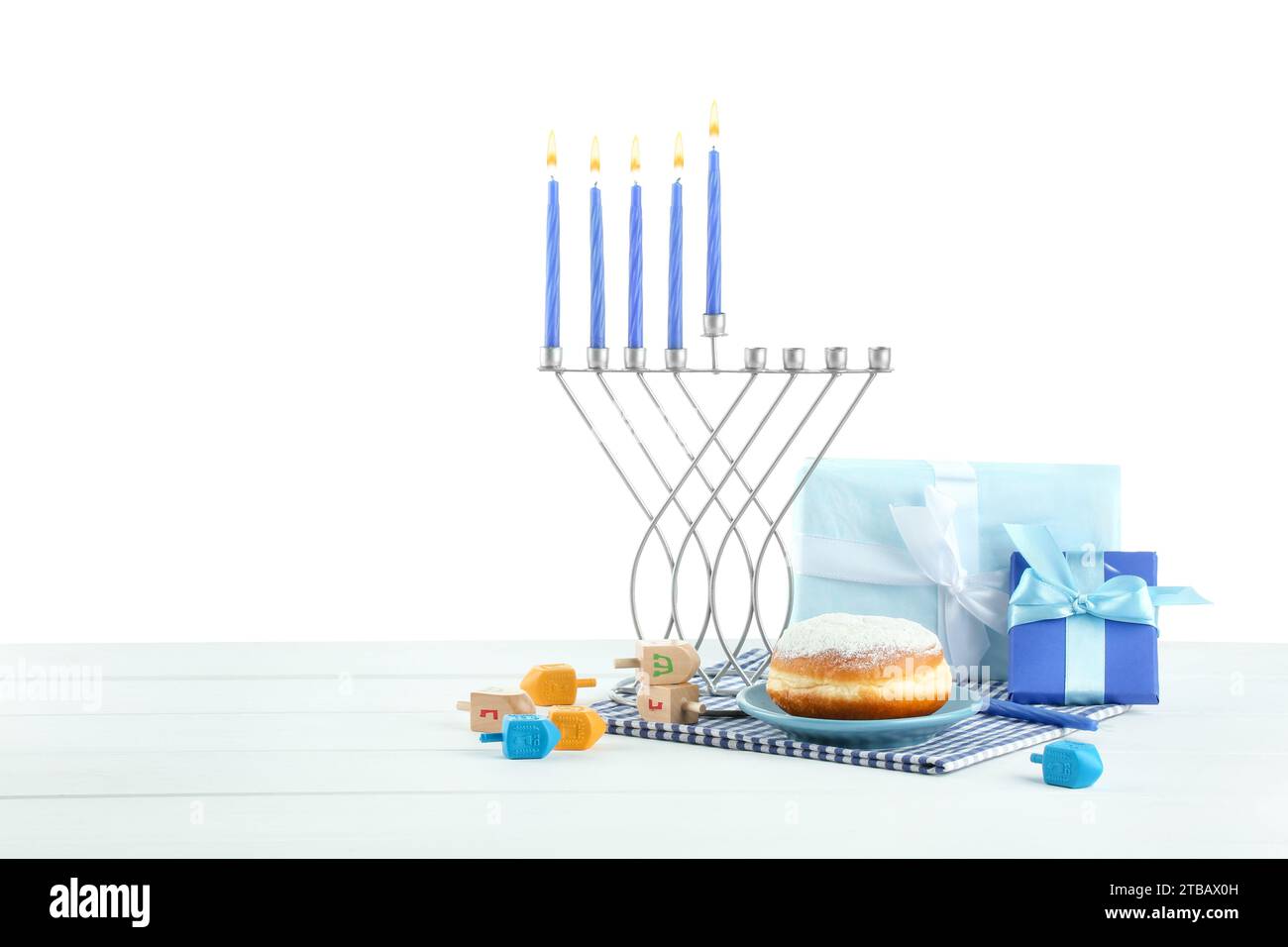 Hanukkah celebration. Composition with menorah, dreidels and donut on ...