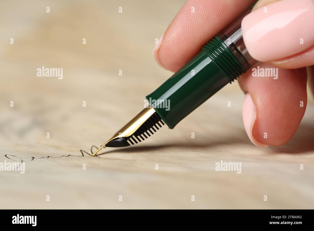 Woman writing letter with fountain pen, closeup Stock Photo - Alamy