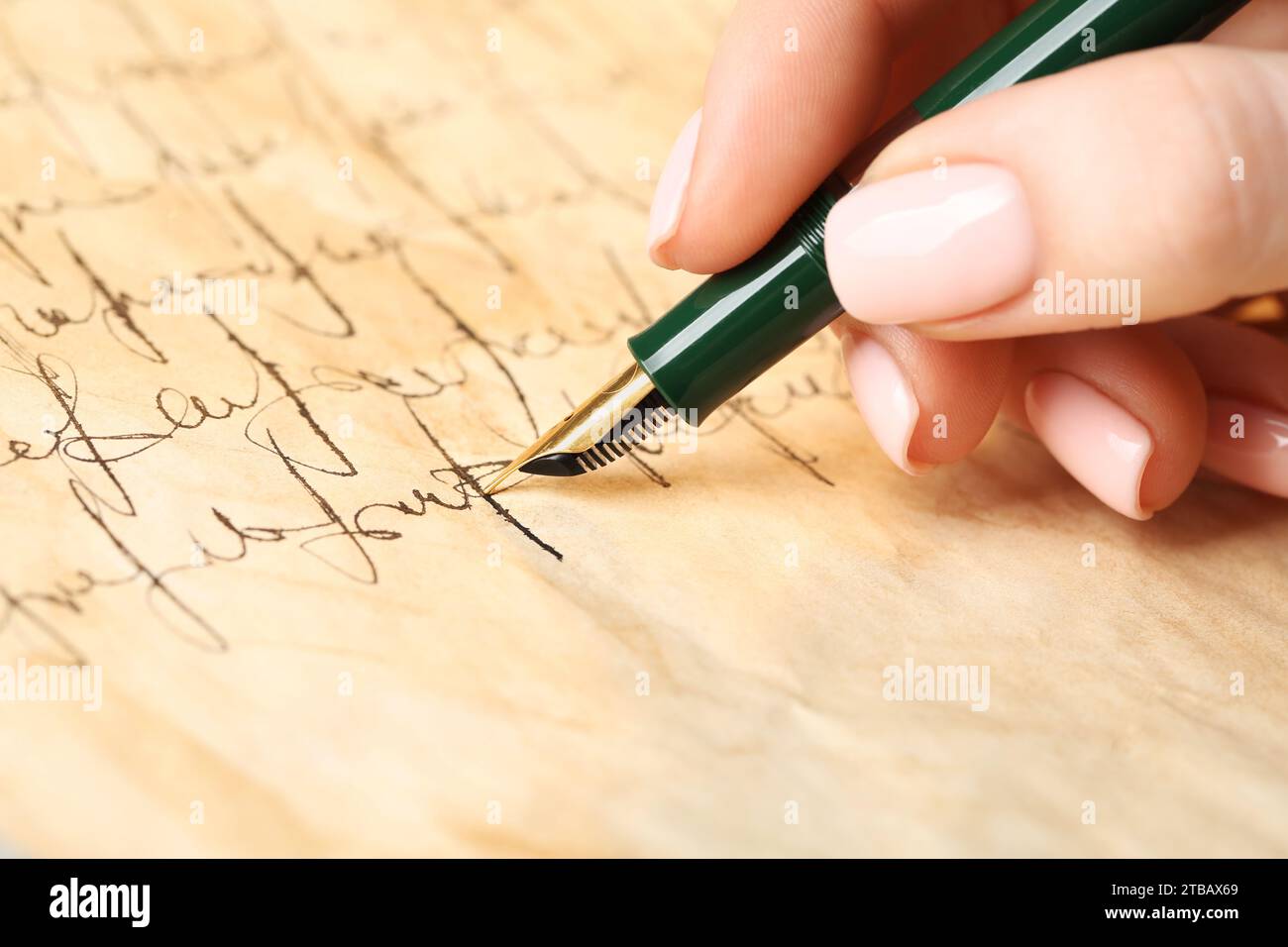 Woman writing letter with fountain pen, closeup Stock Photo - Alamy