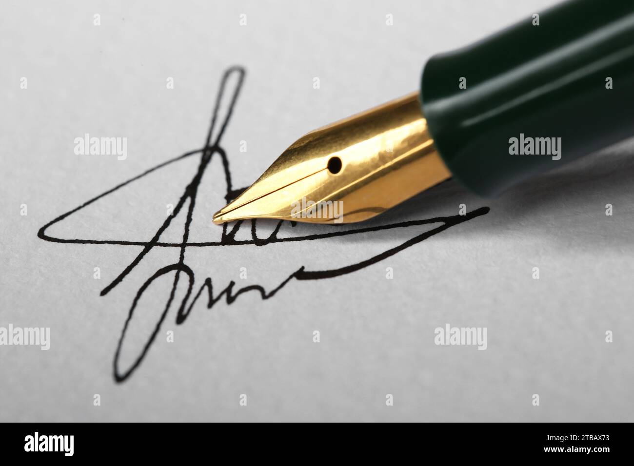 Signing on sheet of paper with fountain pen, closeup Stock Photo - Alamy