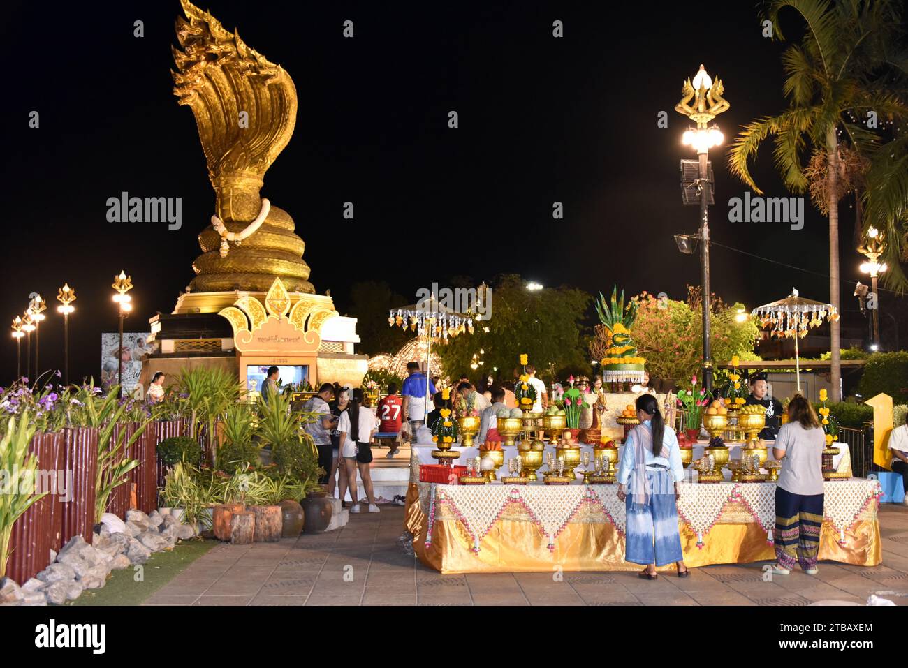 Night image of the Naga Monument, devotees in front, built in 2016 in ...