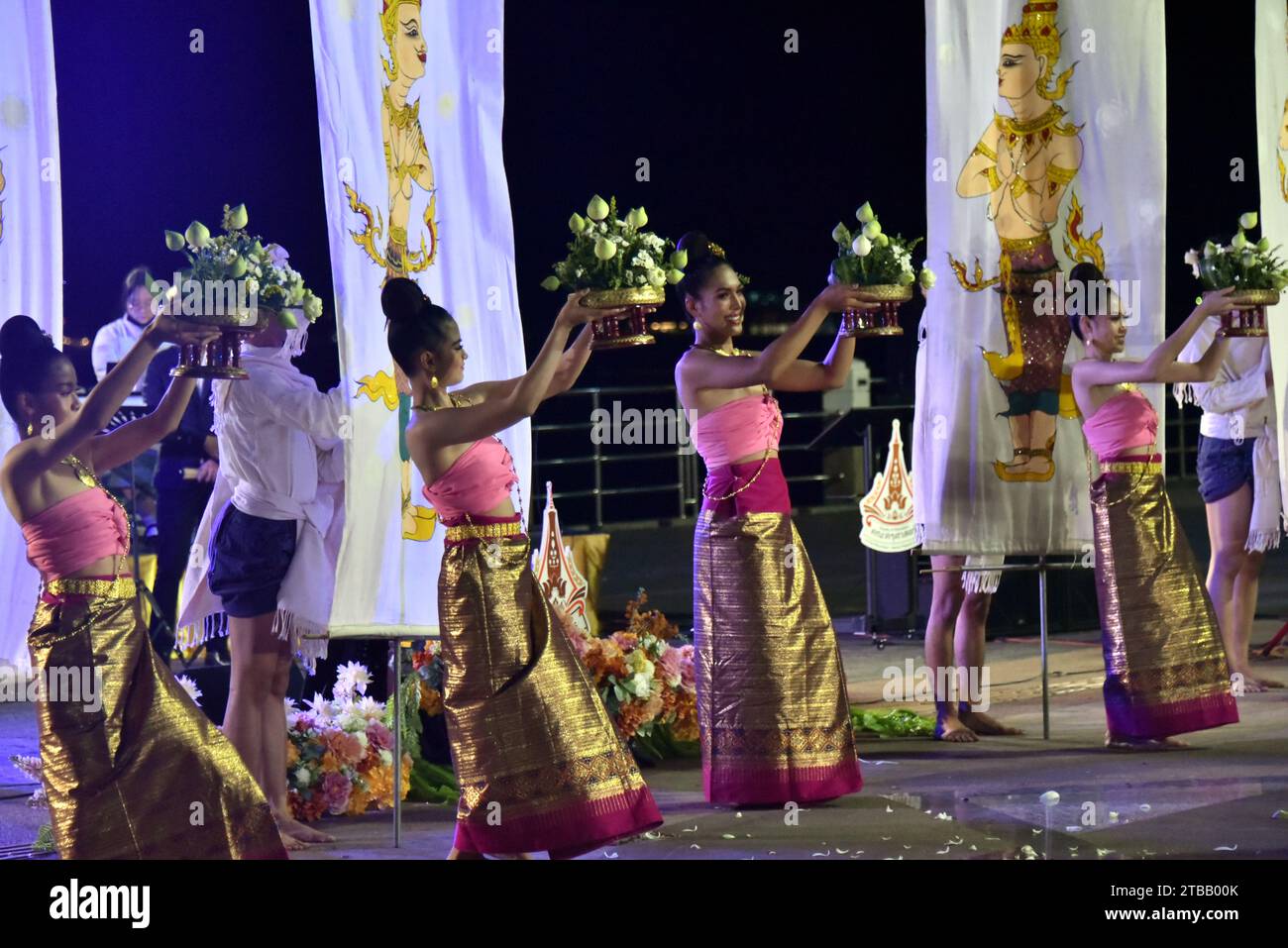 Traditional Isaan morlam dancers in elaborate costumes; young people ...