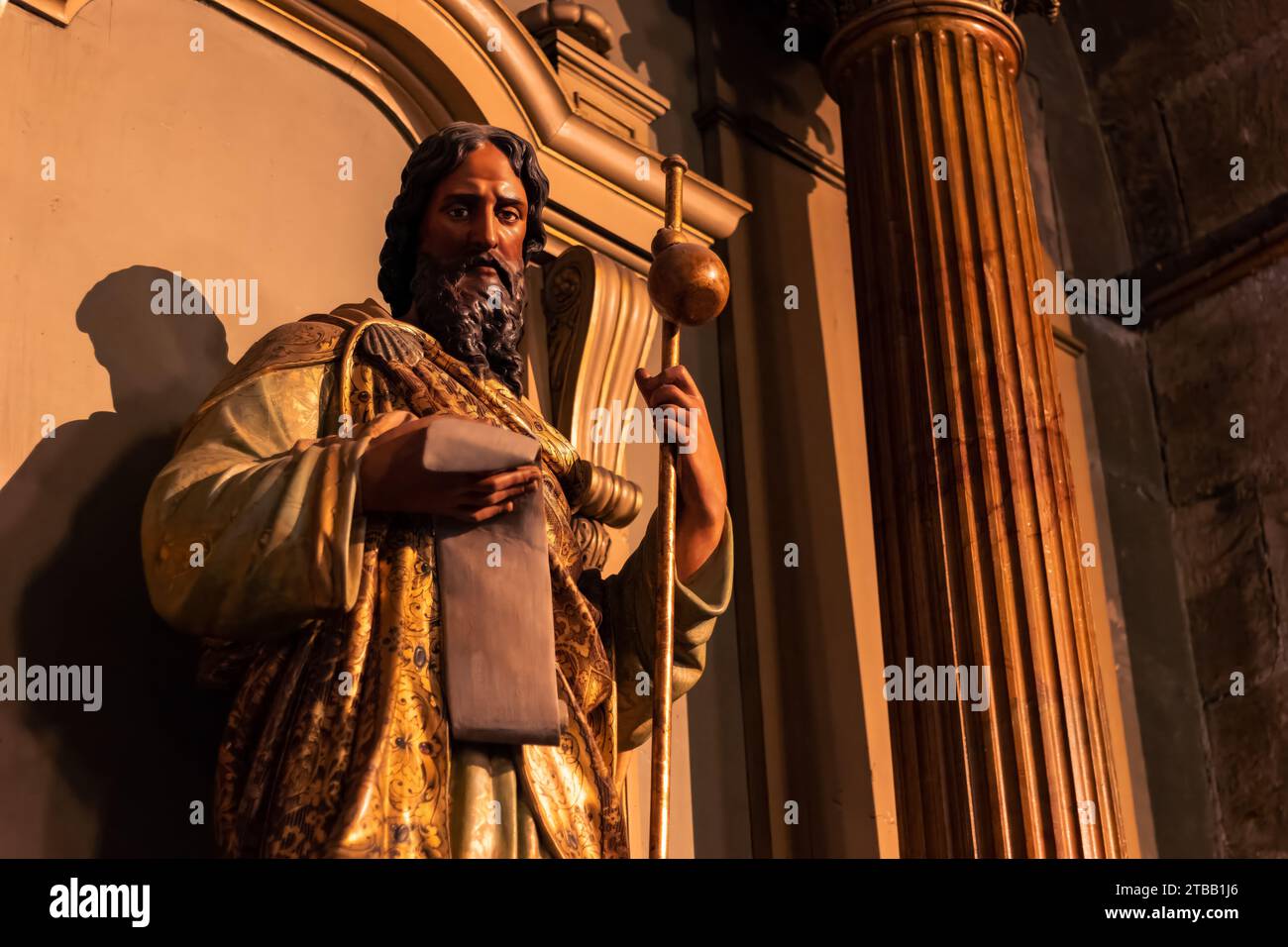 golden ancient statue of god, jesus looking, in a church with classical ...