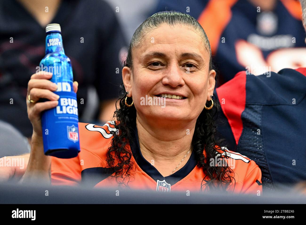 A Denver Broncos fan holds a Bud Light beer can during an NFL football ...