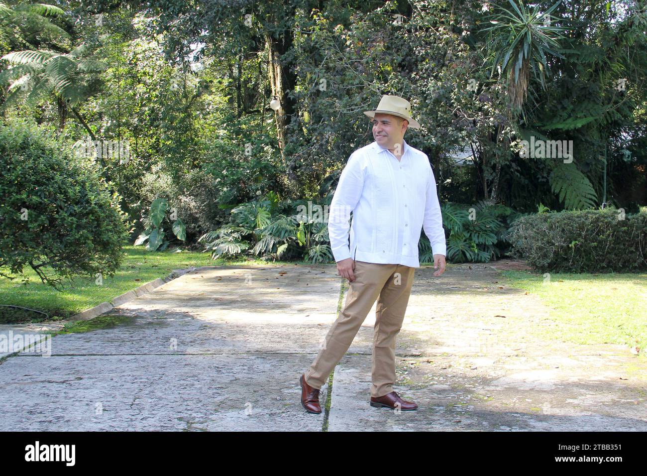 A 40-year-old dark-skinned Latin man very elegantly wears a guayabera ...