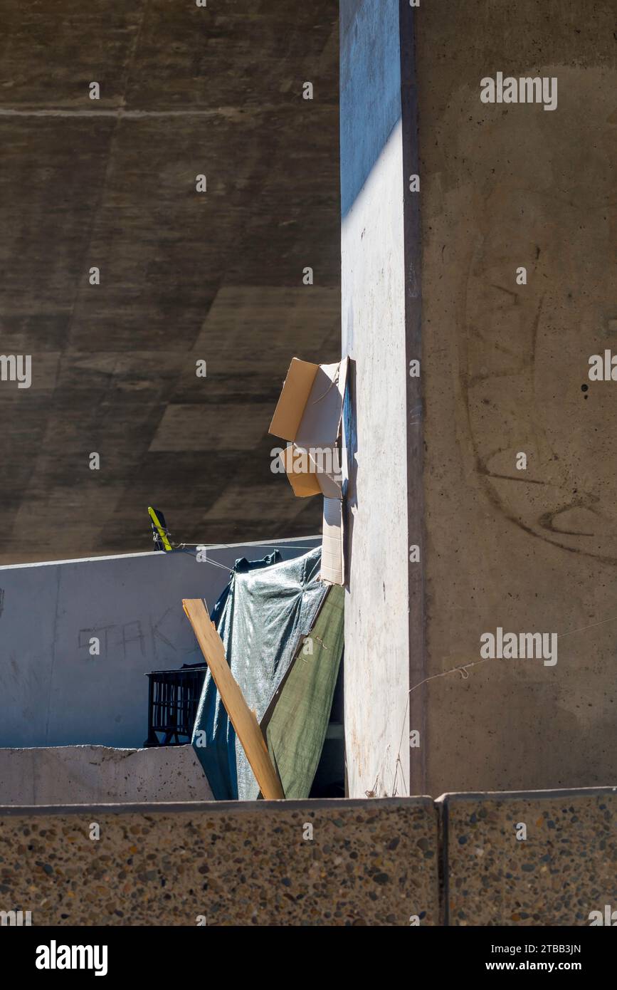 A homeless person's makeshift shelter tucked in a corner under a ...