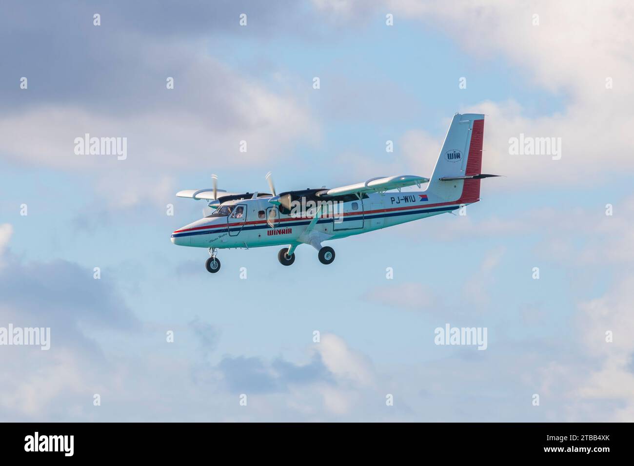 Winair (Windward Islands Airways) DHC-6 flying over Maho Beach before ...