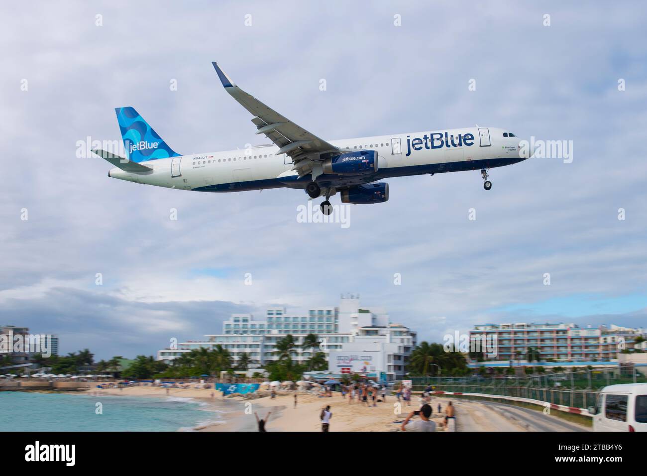 JetBlue Airways Airbus 320 flying over Maho Beach before landing on ...