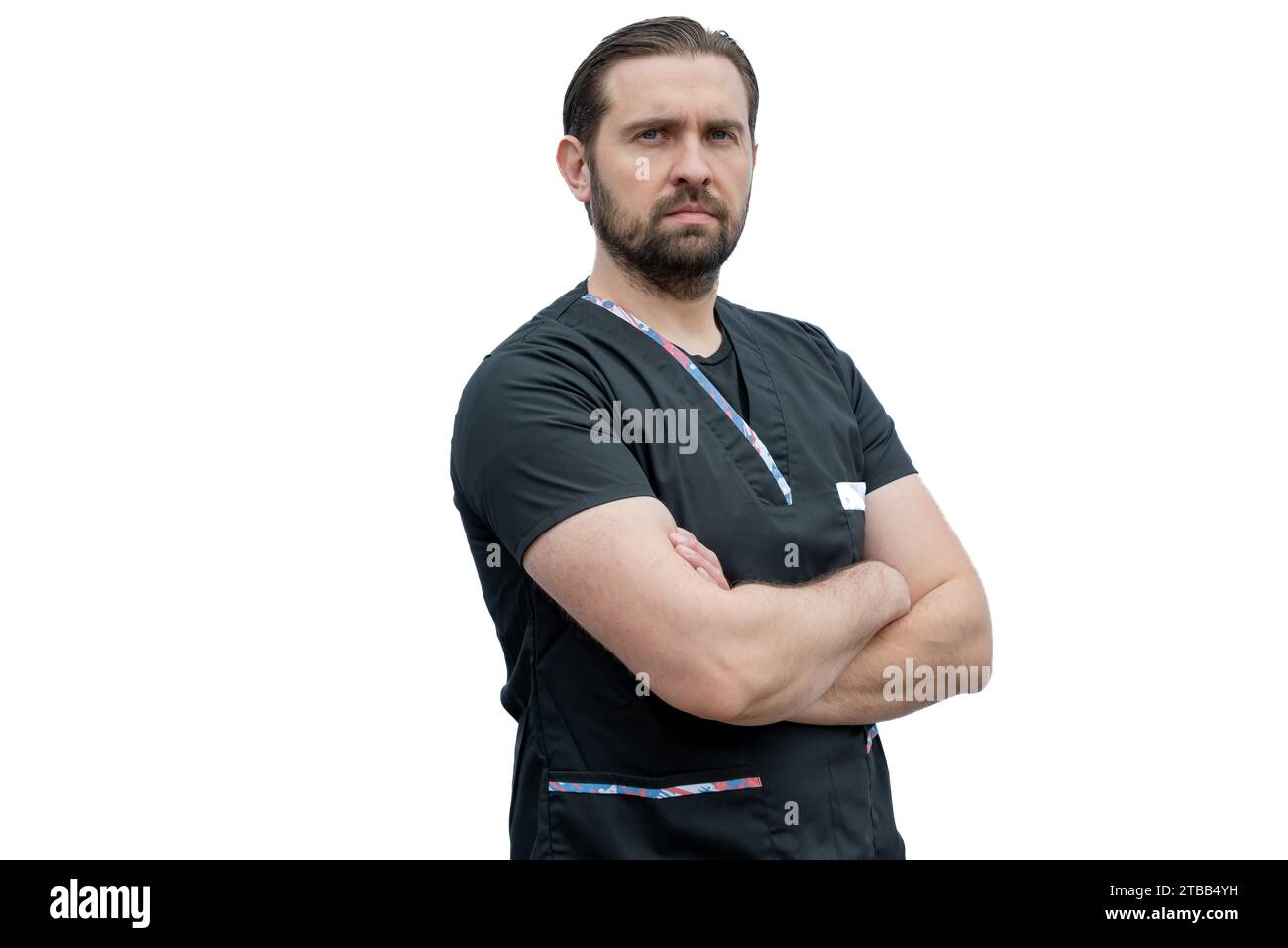 Semi-profile doctor looking seriously at the camera with his arms ...