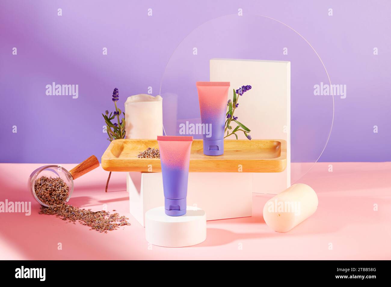 Front view of two cosmetic tubes displayed on platforms, a wooden tray ...