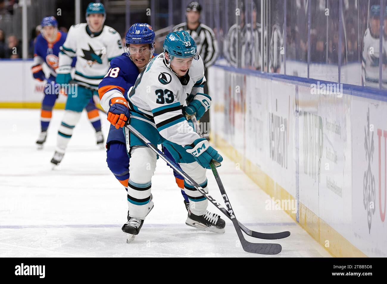 San Jose Sharks defenseman Calen Addison (33) and New York Islanders ...