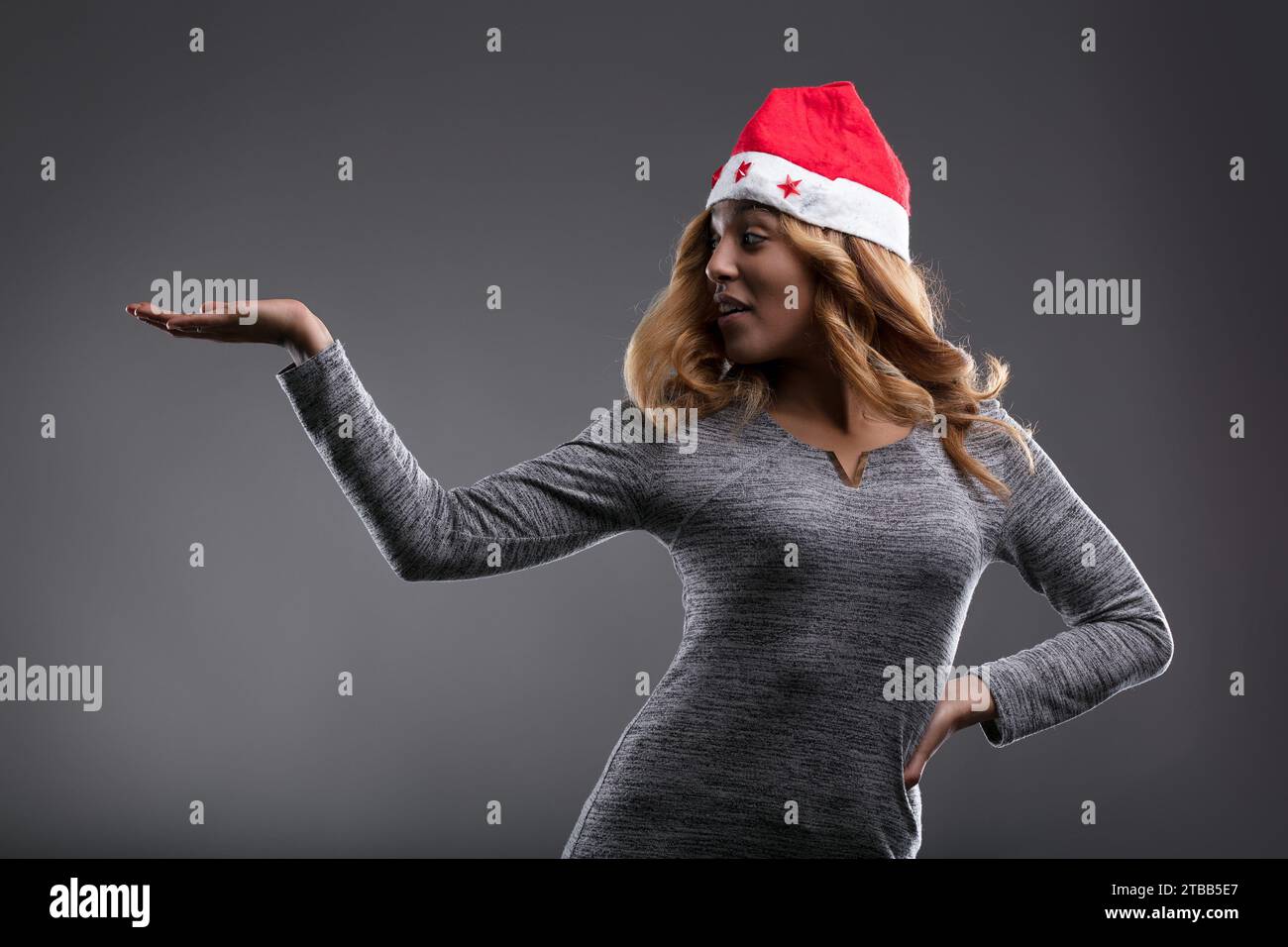 Her exuberant expression under the Santa hat is a burst of holiday ...
