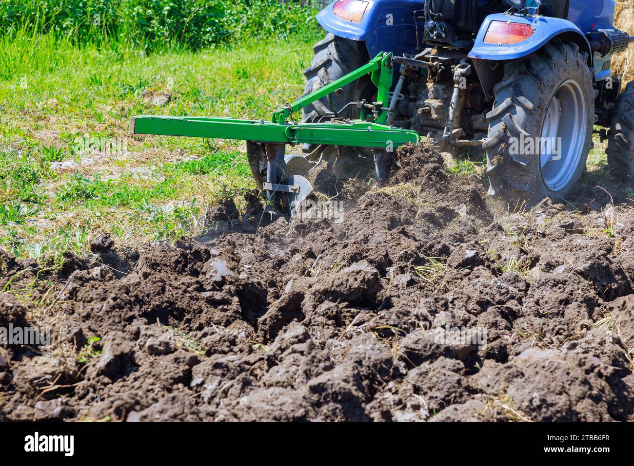 Farmer in tractor prepares ground for sowing for spring season Stock ...