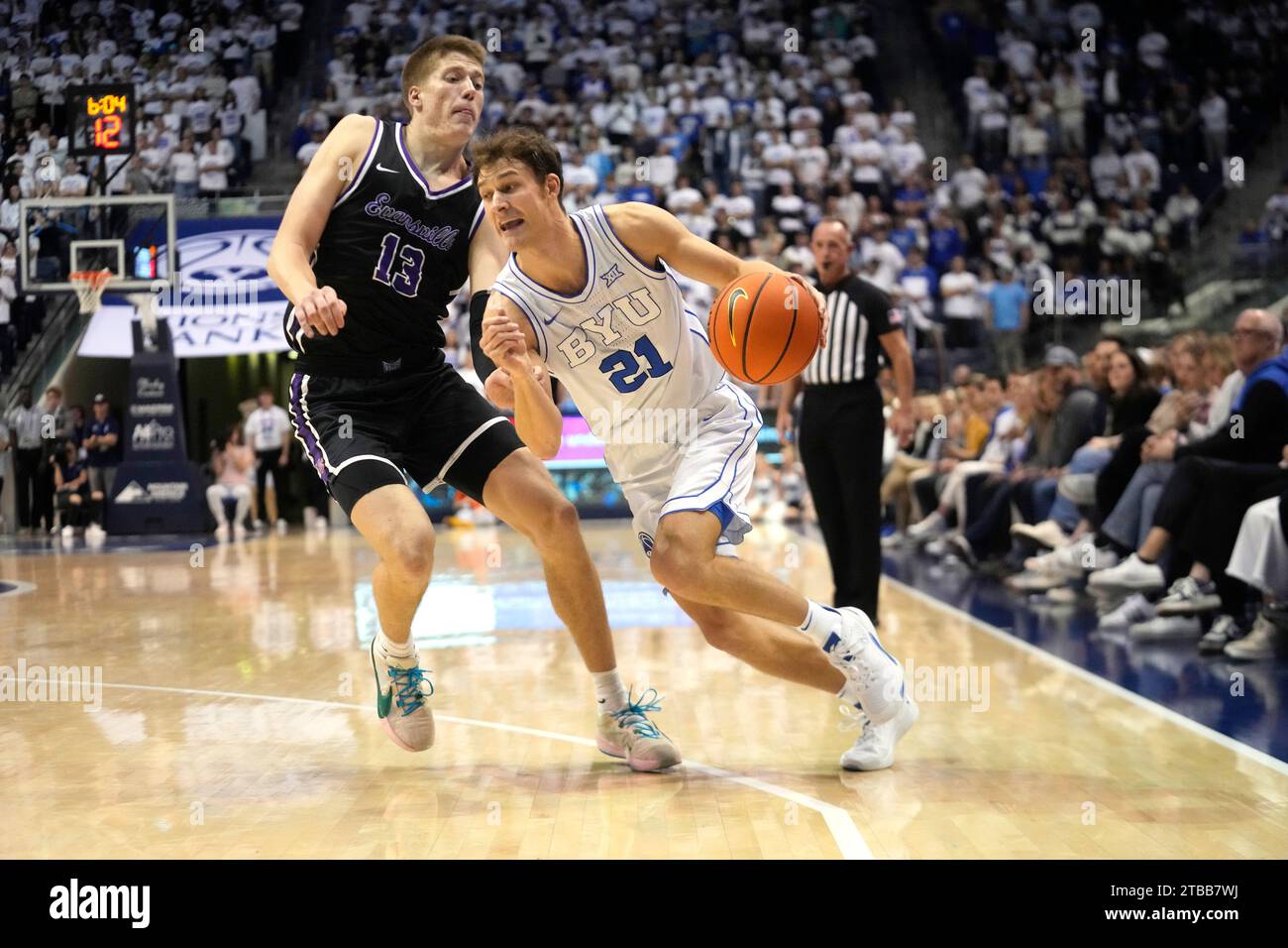 BYU guard Trevin Knell (21) drives around Evansville forward Ben ...