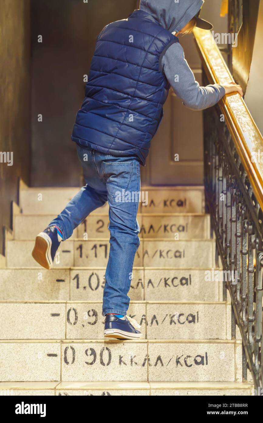 Boy wearing jeans and vest goes upstairs with burnt calories marks on ...