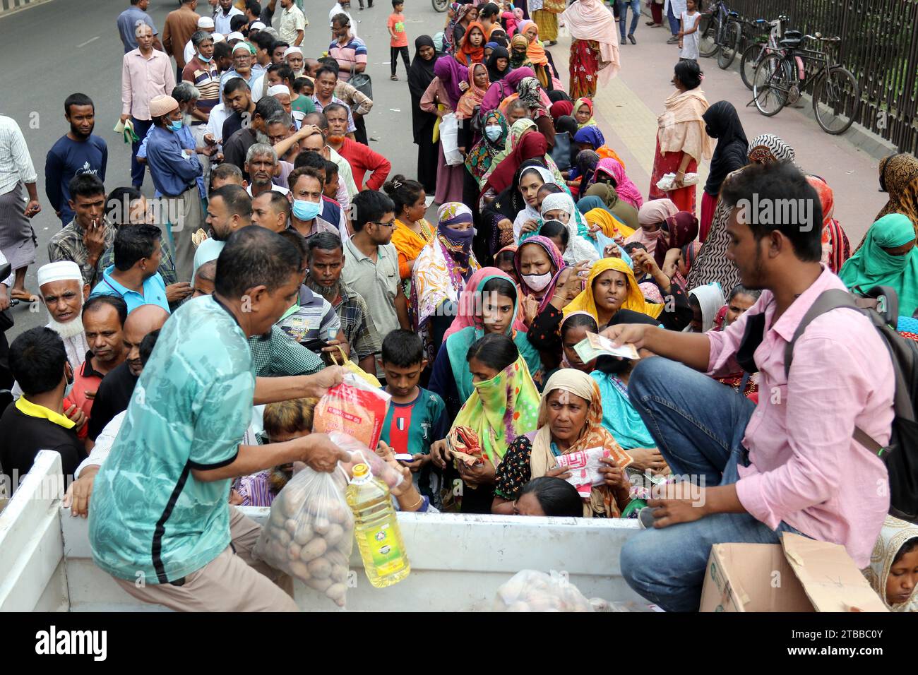 Dhaka, Bangladesh. 04th Dec, 2023. People wait in a queue to buy ...