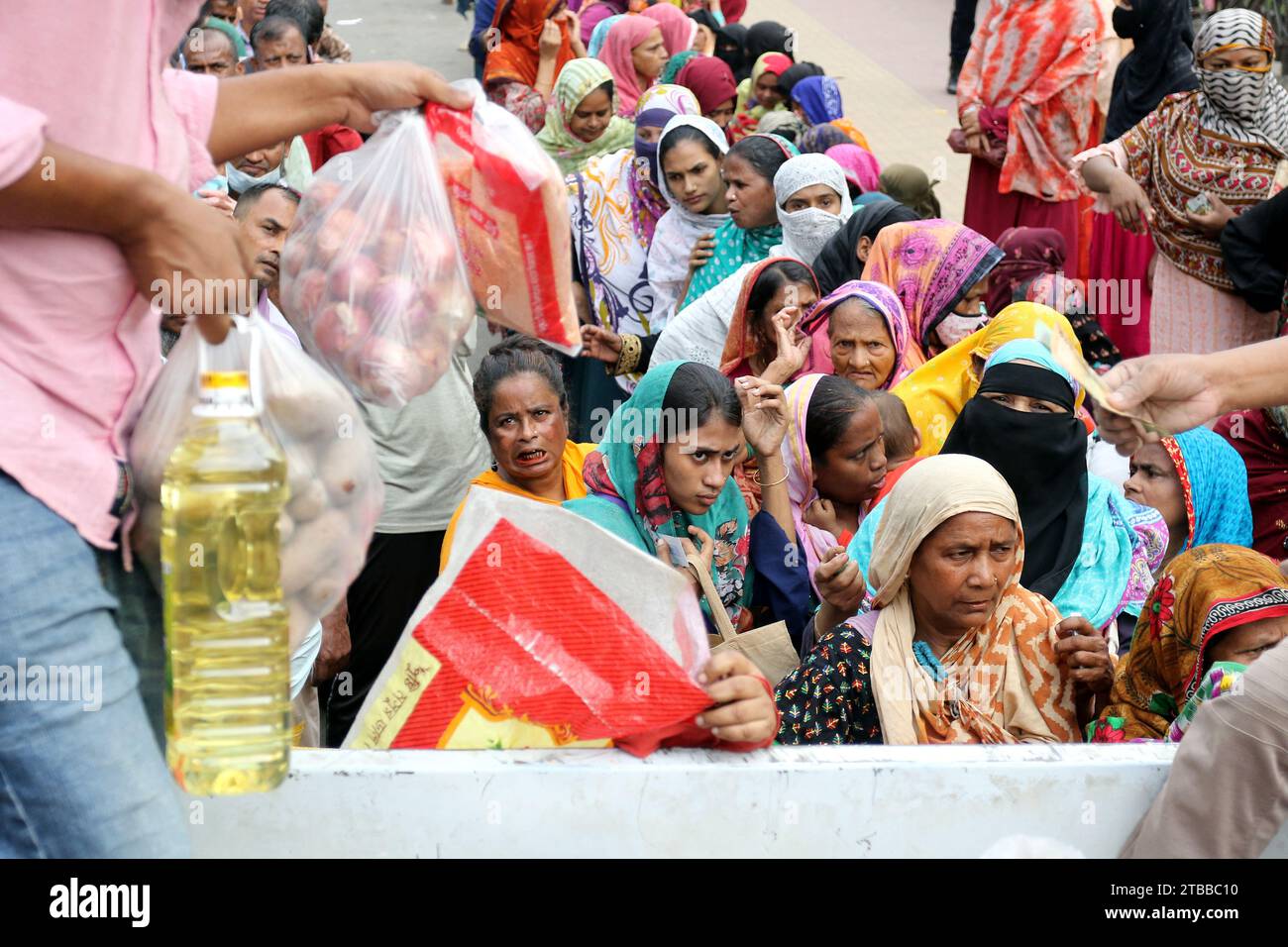 Dhaka, Bangladesh. 04th Dec, 2023. People wait in a queue to buy ...