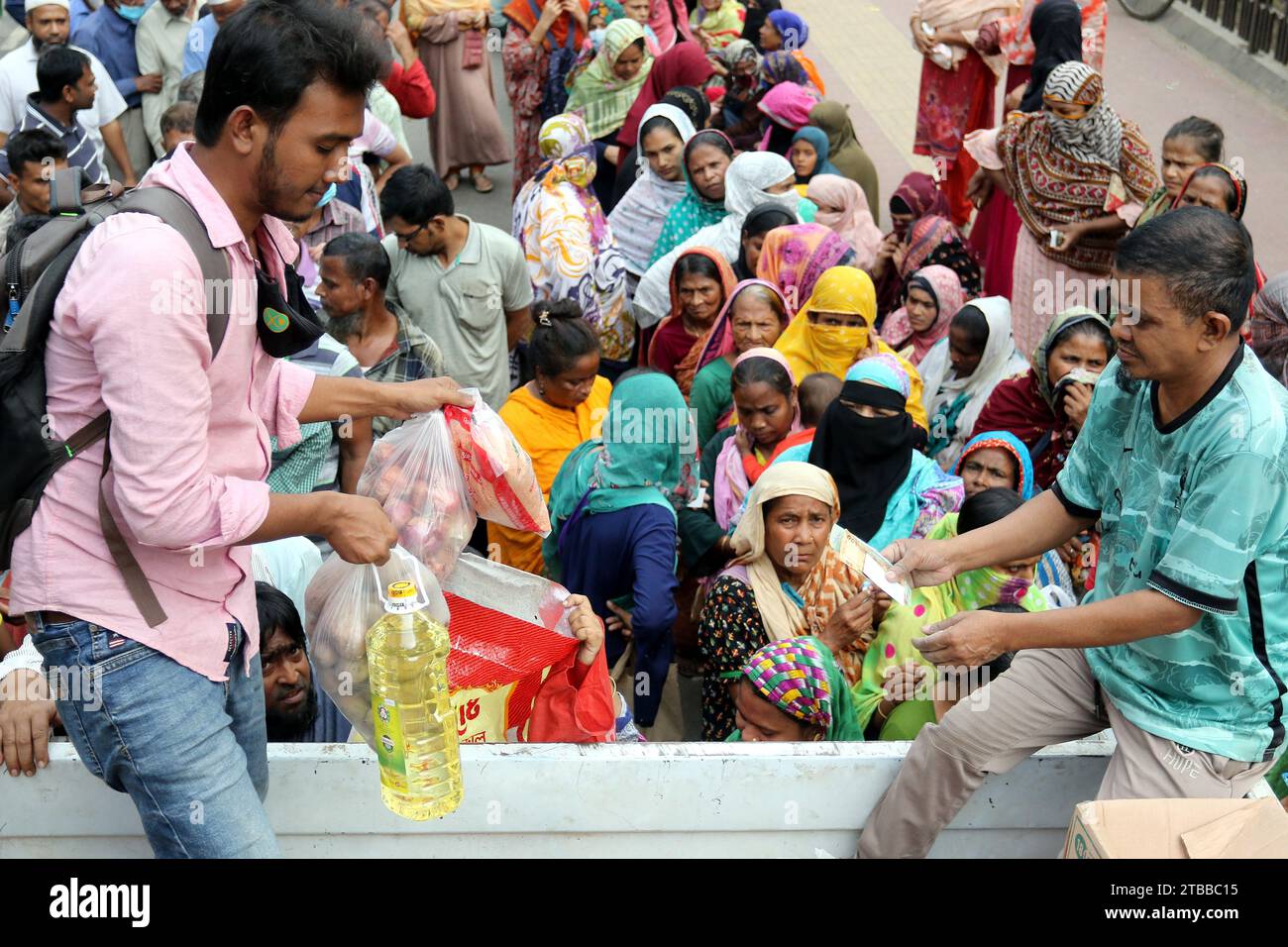 Dhaka, Bangladesh. 04th Dec, 2023. People wait in a queue to buy ...