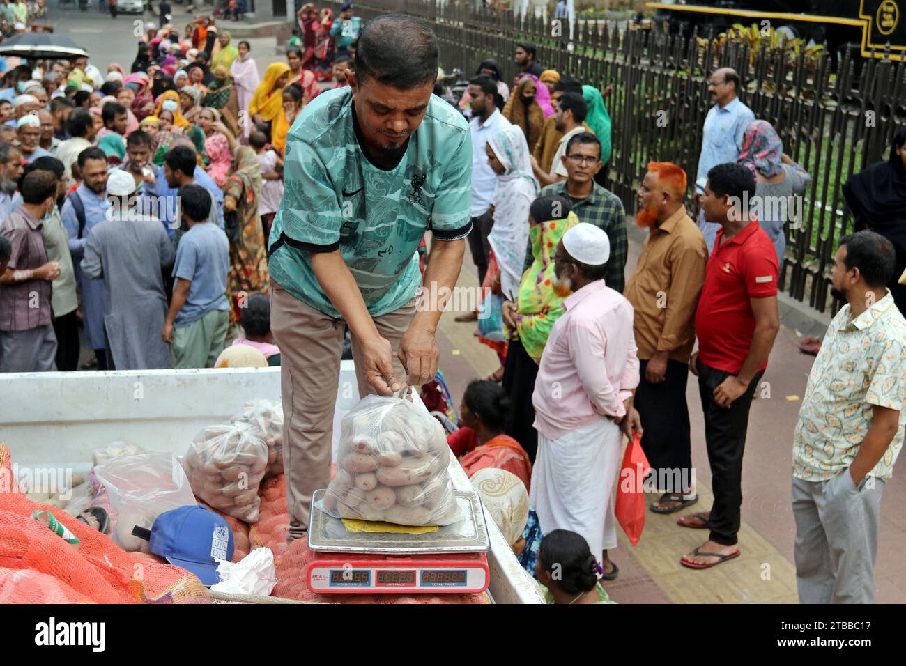 Dhaka, Bangladesh. 04th Dec, 2023. People wait in a queue to buy ...