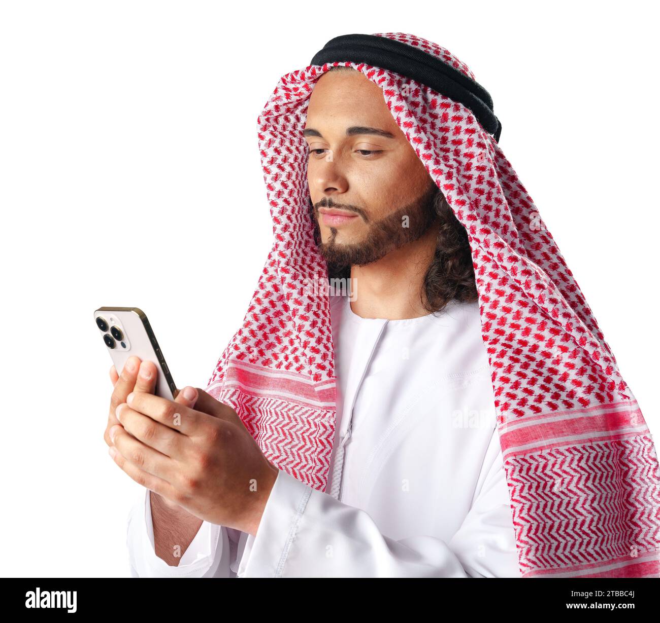 Young Arab man in traditional dress thobe using smartphone at white ...