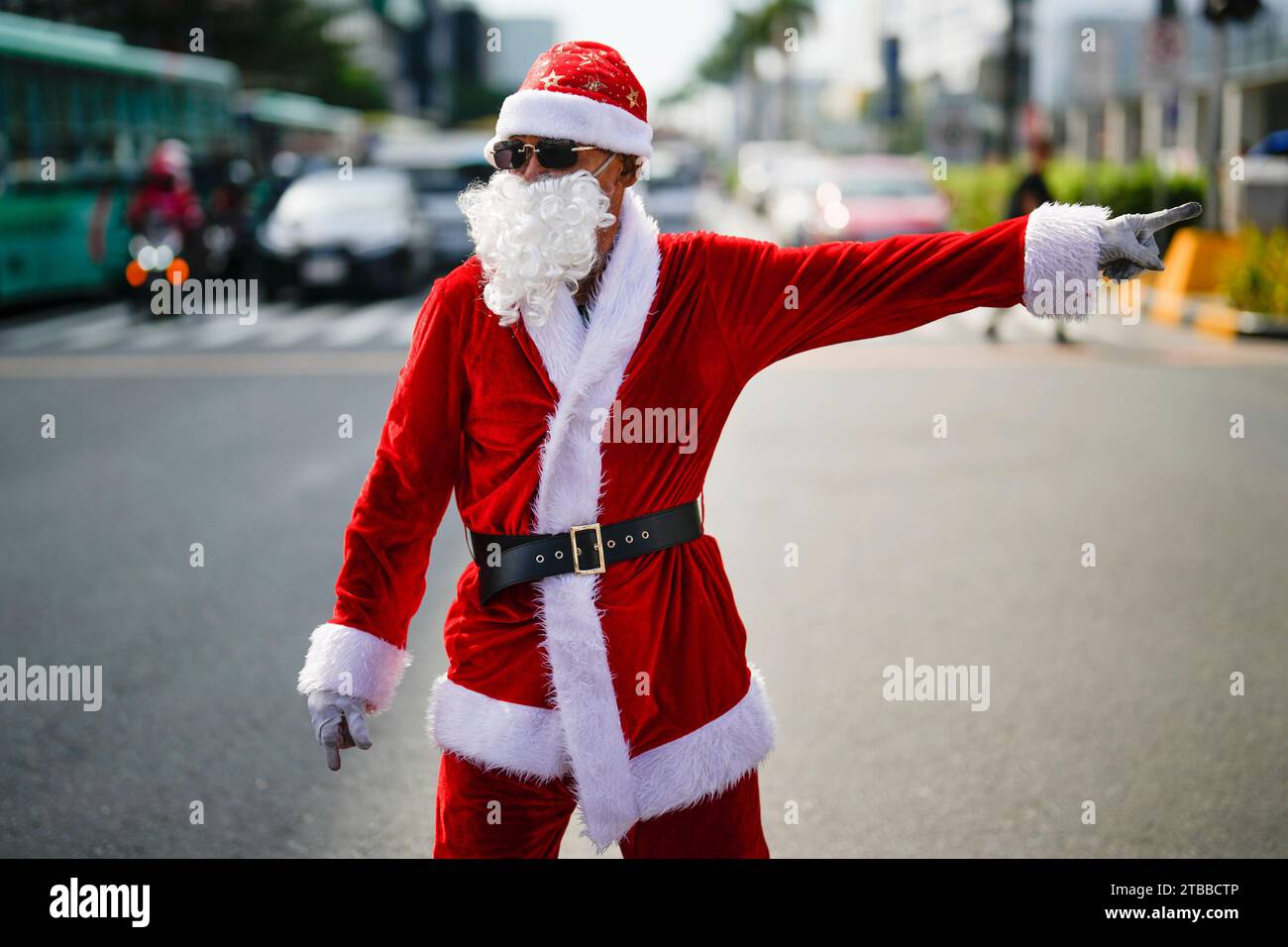 Filipino traffic enforcer Ramiro Hinojas wears a Santa Claus costume as ...