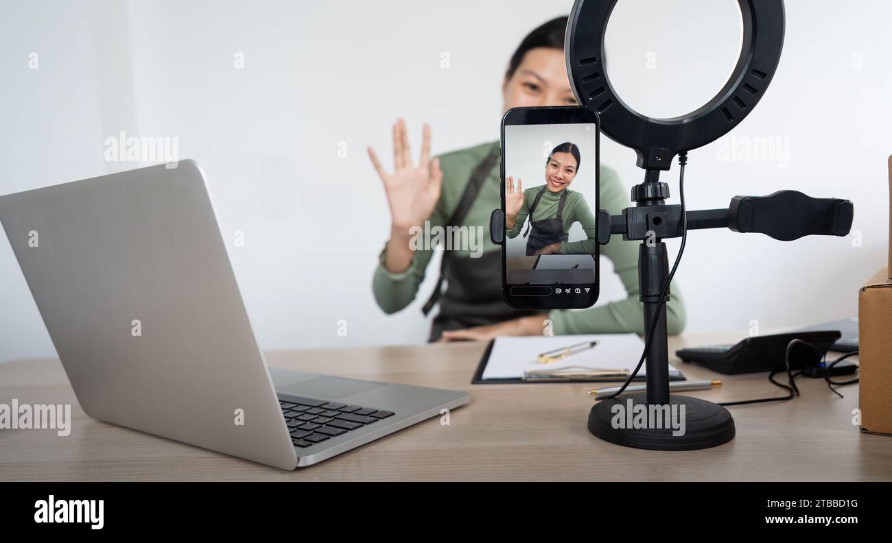 Beautiful asian woman blogger in front of camera to recording vlog ...