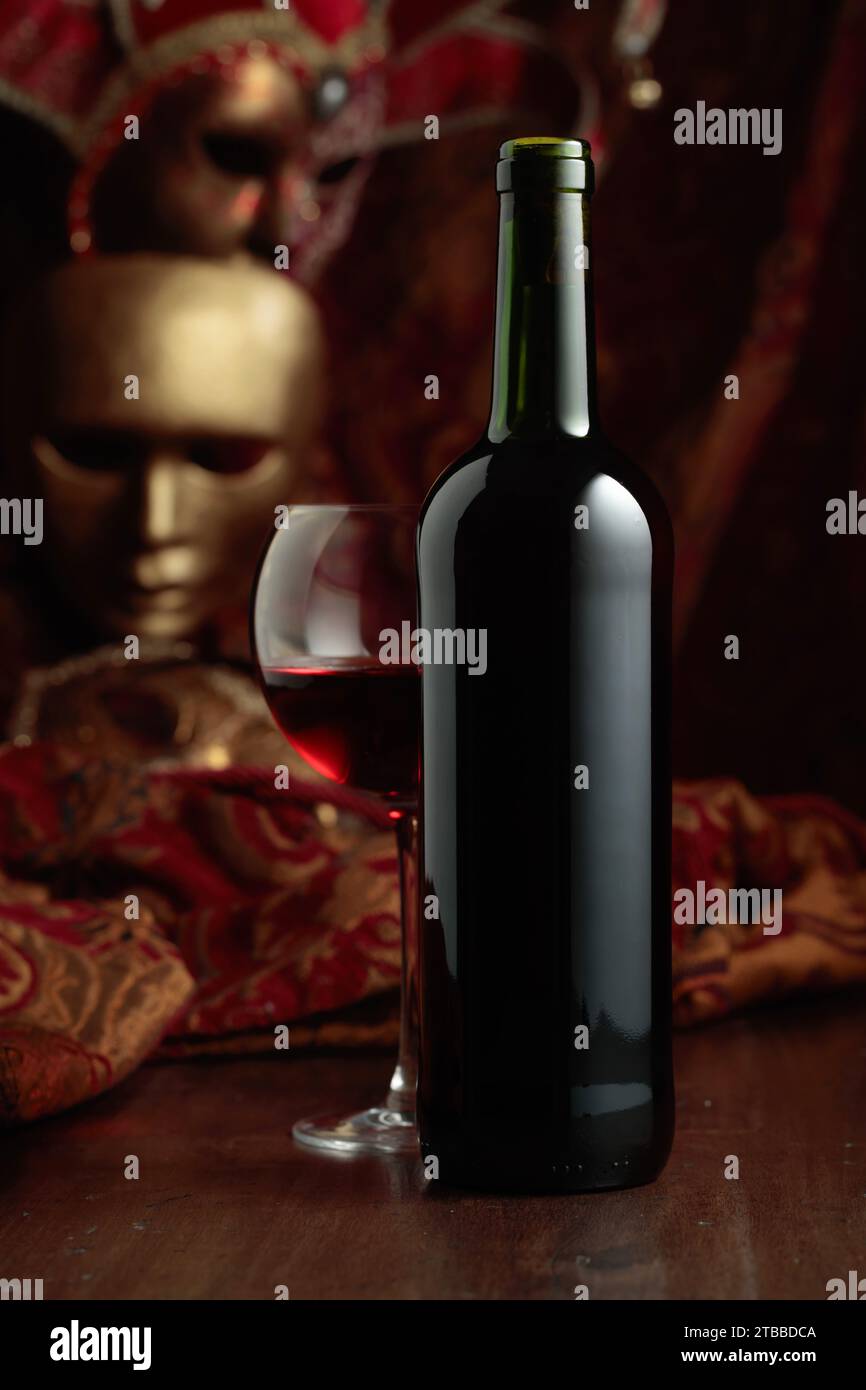 Still life with red wine and vintage carnival masks Stock Photo - Alamy